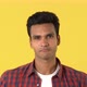 Young Indian man in plaid shirt saying yes by shaking his head against ...