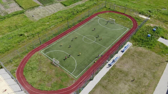 Aerial View Children Play Football on a Small Football Field. Modern ...