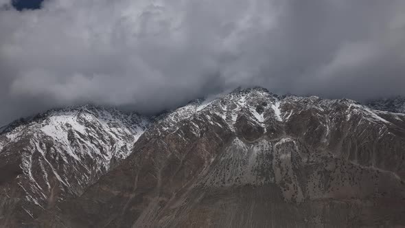 Ominous Clouds Above Peaks Of Snow Covered Mountains In Hunza, Pakistan ...