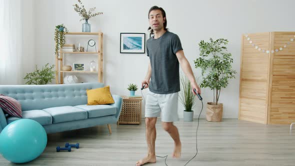 Portrait of Fit Guy Skipping with Rope and Talking Looking at Camera ...