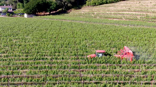 Farm Tractor Spraying Pesticides and Insecticides Herbicides Over Green ...