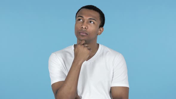 Pensive Young African Man Thinking, Blue Background, Stock Footage
