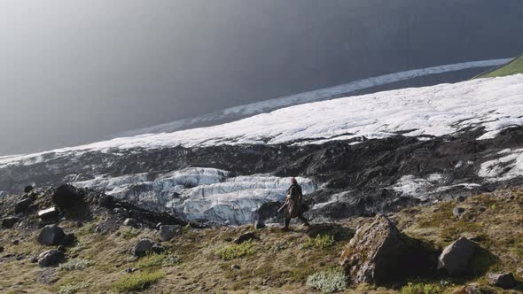 Travelling Man Walking Along Ridge Over Glacier And Valley, Stock Footage