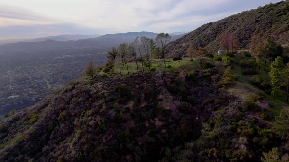 A drone shot pushing in on a clearing on an overlook at the top of a ...