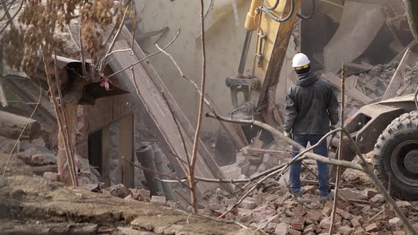 Engineer with Protective Helmet Looks at Demolition Destruction of Old ...