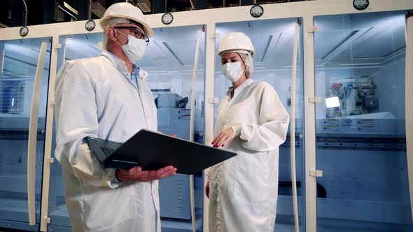 Two Engineers in Lab Coats are Discussing Modern Technologies, Stock ...