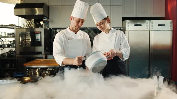 Professional kitchen: liquid nitrogen is added during the cooking of a ...