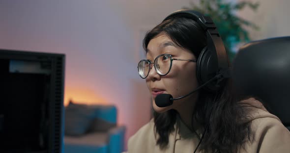 Girl with Nerd Glasses Playing Games on the Computer Gamer Sits in a ...