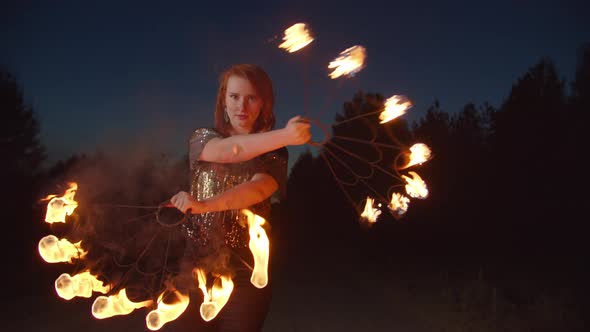 Fire Juggler Performing at Night with Two Fire Fans, Stock Footage