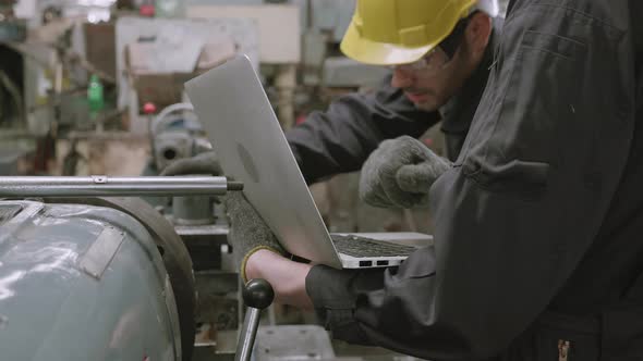 Two engineer man training work with laptop computer together in factory ...