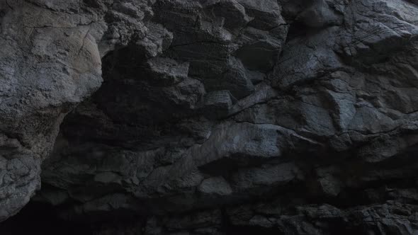 Mystical Grey Hilly Cave with Large Rocks Over Sea Water, Stock Footage