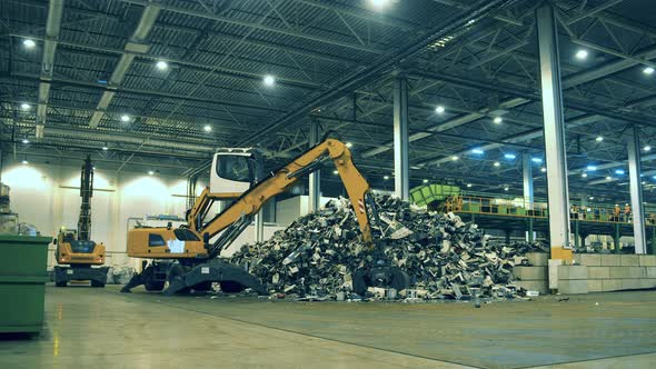 Indoors Landfill with a Loader and a Pile of Rubbish. Electronic ...