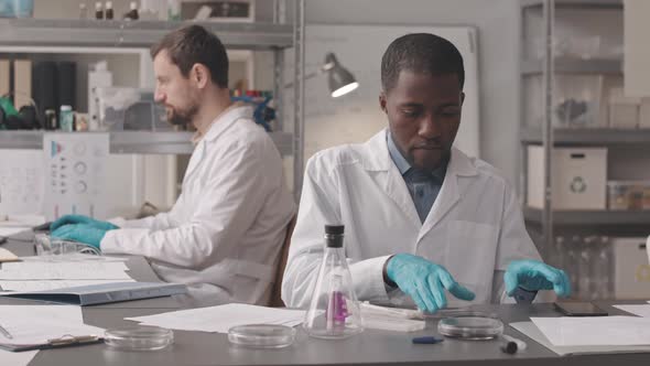 African American Chemist Taking Picture of Substance in Petri Dish ...
