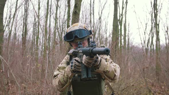 Armed Young Man in a Zone of Armed Conflict in Uniform Targeting with ...