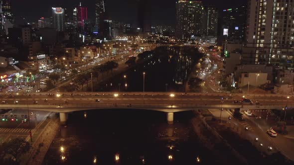 tracking aerial view across traffic bridge, underpasses and busy main ...