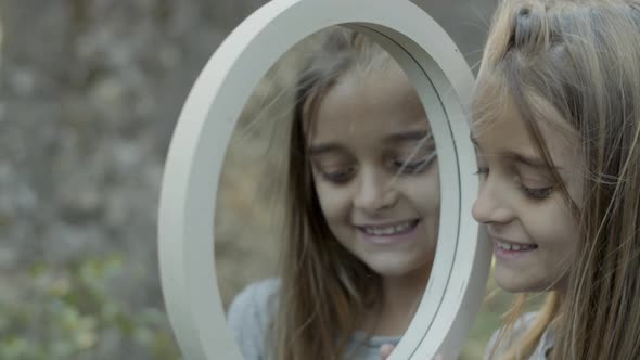 Happy Girl Holding Mirror and Looking Into Her Reflection, Stock Footage