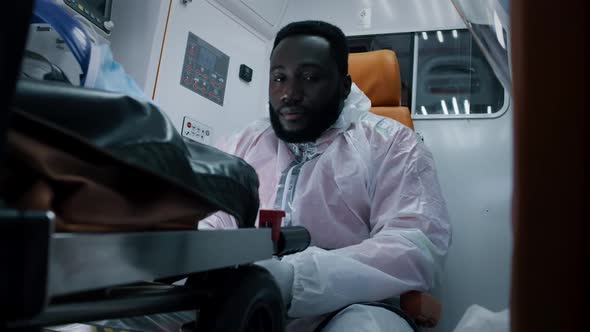 Exhausted African American Paramedic Riding Ambulance, Stock Footage