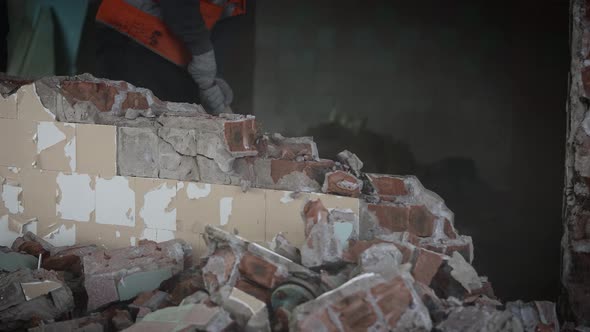 Dismantling an Unnecessary Brick Wall During Construction Work in an ...
