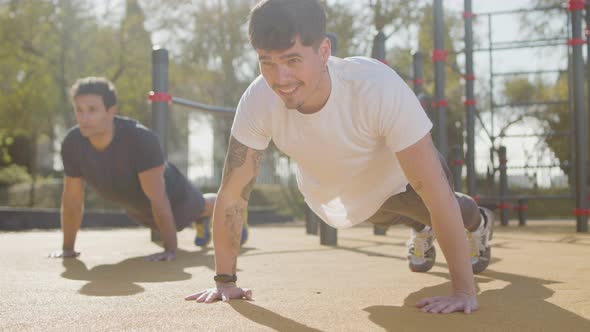 Buddies Doing Push Ups Together on Sports Ground, Stock Footage | VideoHive