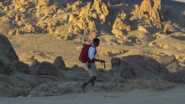 A young man backpacking in a mountainous desert., Stock Footage | VideoHive