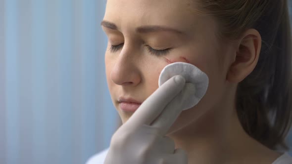 Doctor Treating Wound on Female Patient Face After Car Accident, First ...