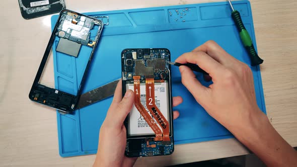 Top View of a Smartphone Getting Dismantled, Stock Footage | VideoHive