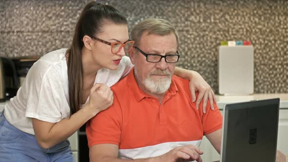 Adorable Brunette and Her Father Stare Intently at the Laptop Screen ...