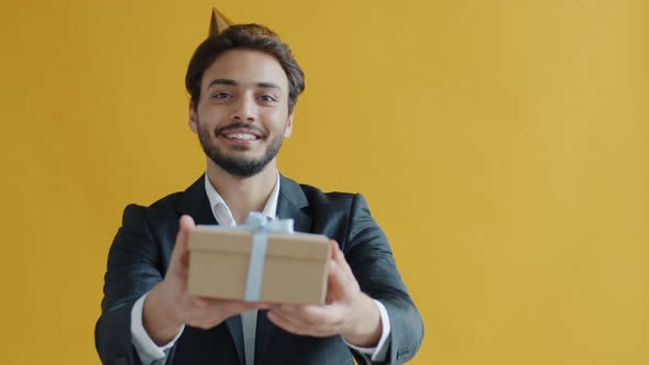 Portrait of Generous Arab Man Giving Beautiful Gift Box Stretching ...