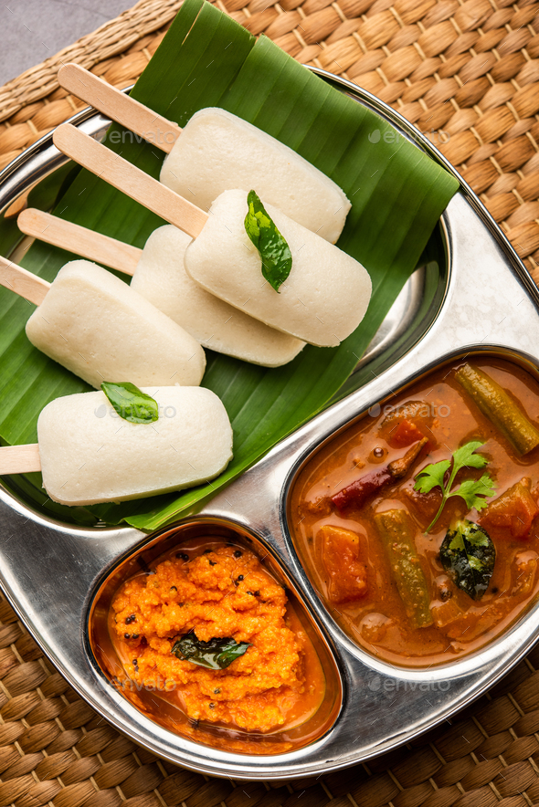 Idly lollipop or idli candy with stick served with sambar and chutney ...