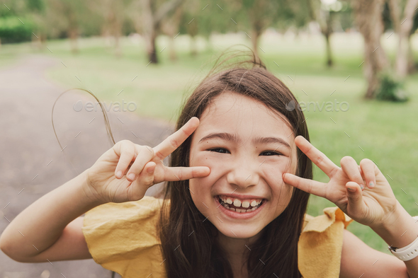 lifestyle portrait of happy mixed Asian girl child face in park Stock ...