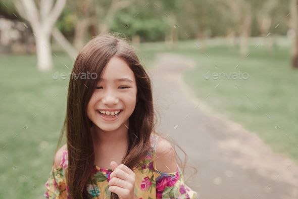lifestyle portrait of happy mixed Asian girl child face in park Stock ...