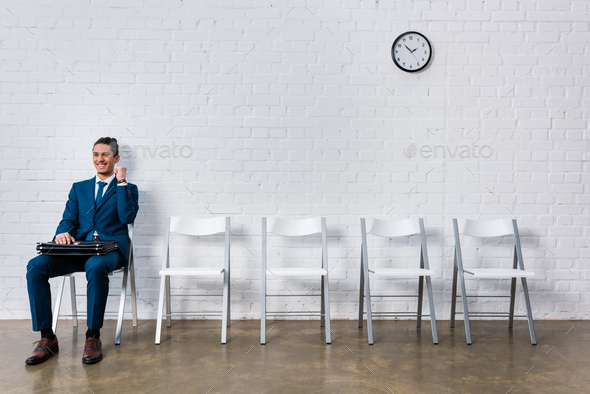 Concept of successful interview with young happy businessman sitting on ...