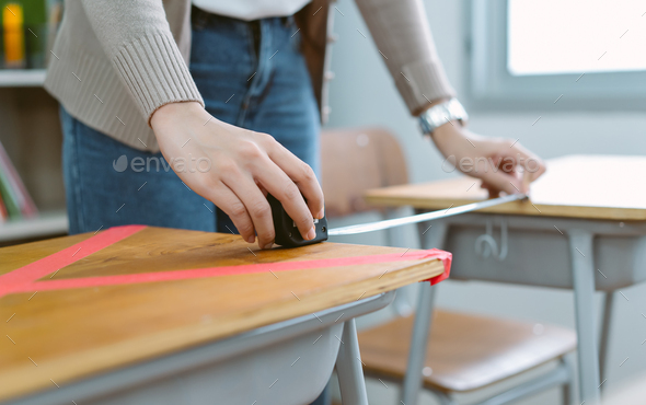 Closeup of Female Teacher measure and marking places distances between ...