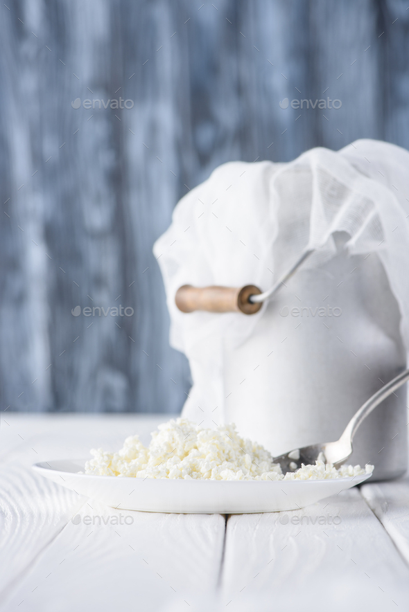 delicious healthy cottage cheese and metal bucket behind on wooden ...