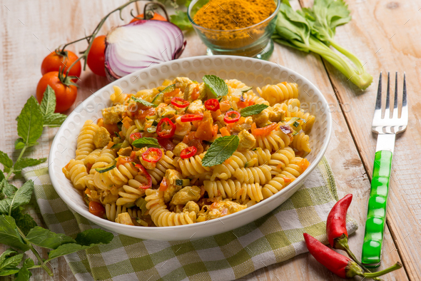 pasta with chicken ragout and curry spice Stock Photo by MarcoMayer
