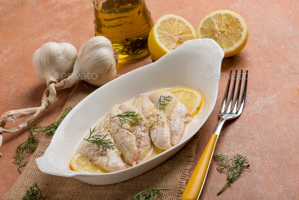 red mullet fillet with lemon sauce and garlic Stock Photo by MarcoMayer