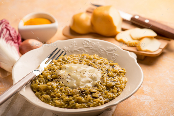 chicory risotto with curcuma and scamorza cheese Stock Photo by MarcoMayer