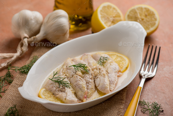 red mullet fillet with lemon sauce and garlic Stock Photo by MarcoMayer