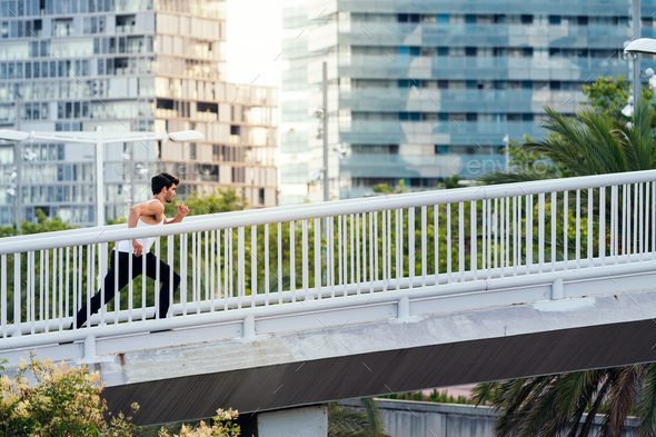 runner running in front of the buildings Stock Photo by Raul_Mellado