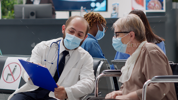 Doctor explaining disease diagnosis to woman with physical impairment ...