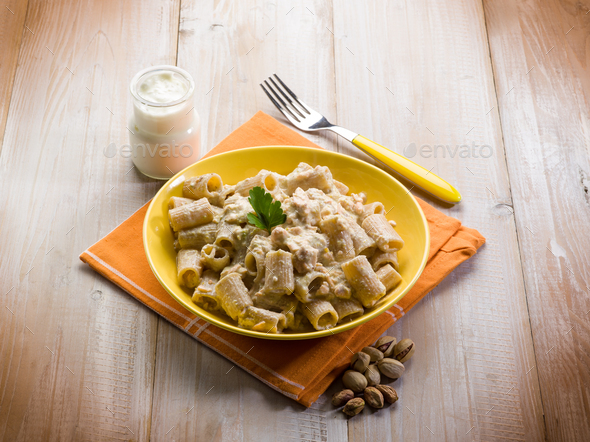 pasta with fish ragout pistachio and cream sauce Stock Photo by MarcoMayer