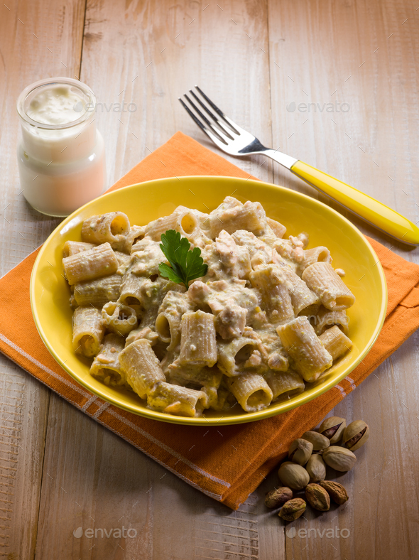 pasta with fish ragout pistachio and cream sauce Stock Photo by MarcoMayer