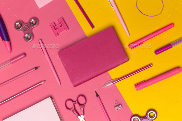 school supplies at colorful paper background Stock Photo by FabrikaPhoto