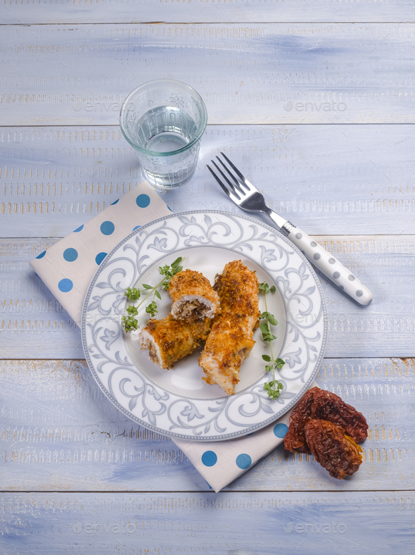 breaded swordfish stuffed with dried tomatoes Stock Photo by MarcoMayer