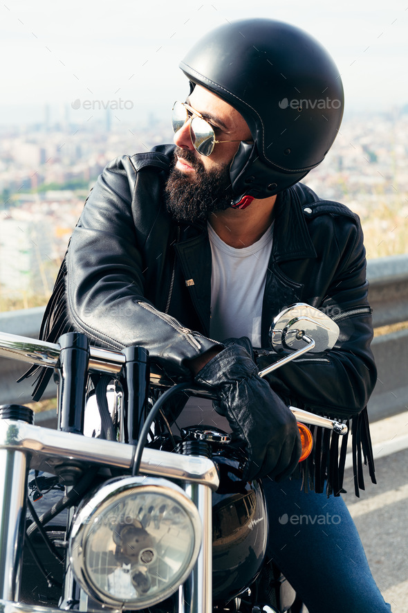 biker sitting on his motorbike with the city far Stock Photo by Raul ...