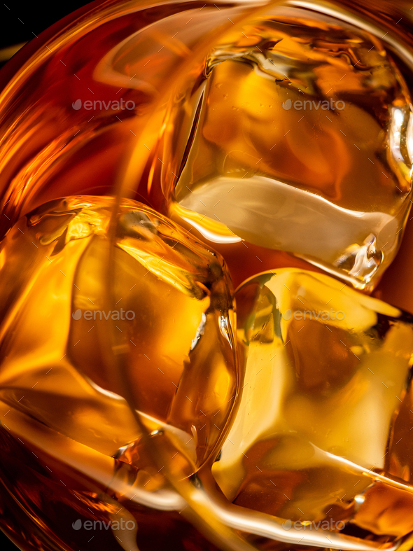 Whisky on the rocks, glass filled with ice cubes Stock Photo by alexbowmore