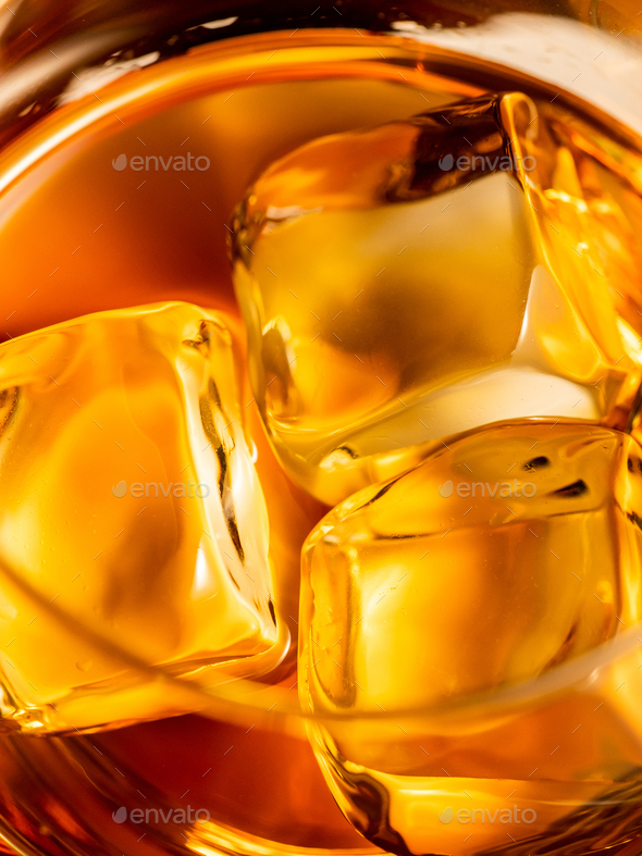 Whisky on the rocks, glass filled with ice cubes Stock Photo by alexbowmore