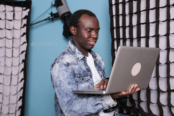 Joyful production director with DSLR camera and handheld computer Stock ...