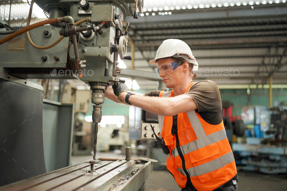 industrial mechanics engineer operating lathe machine for metalwork in ...