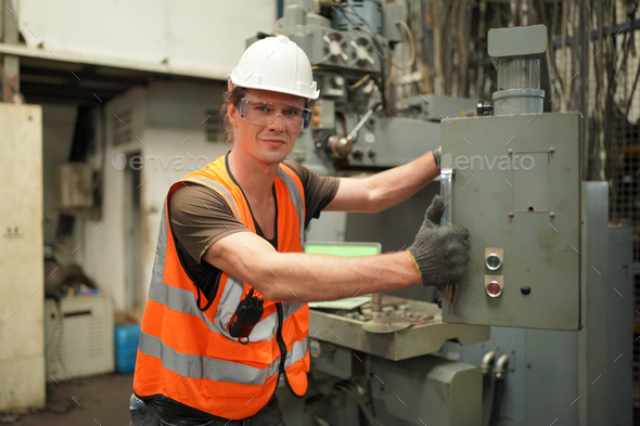 industrial mechanics engineer operating lathe machine for metalwork in ...